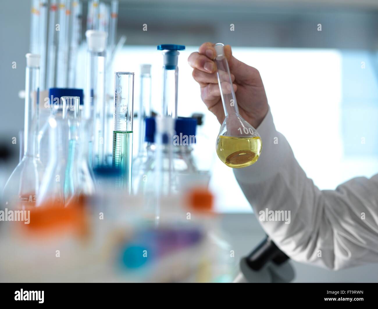 PROPERTY RELEASED. MODEL RELEASED. Scientist holding a chemical formula ...