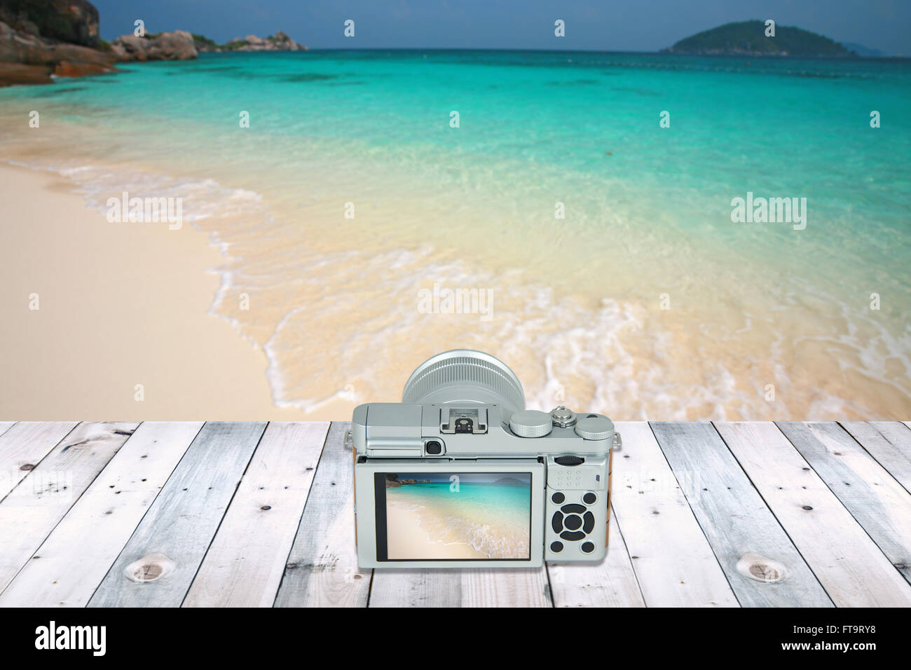 camera with screen display on wooden table with beautiful landscape in ...