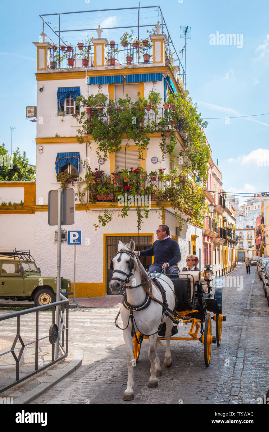 picturesque house in Triana with horse-drawn carriage Stock Photo - Alamy