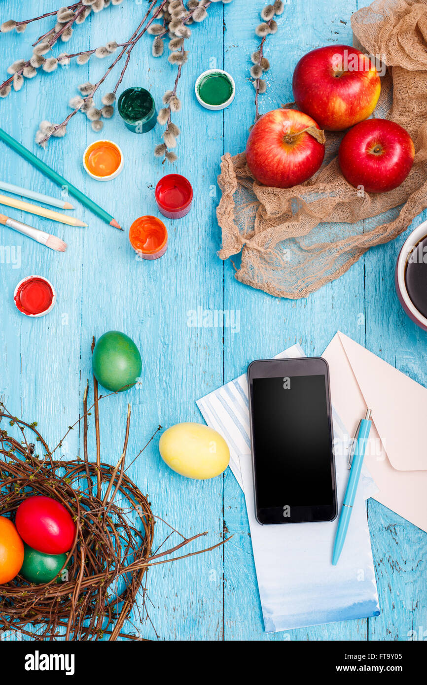 Easter in the office workplace on blue wooden table. Top view with ...