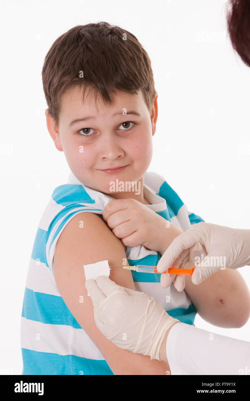 Doctor giving a child injection in arm on isolated image Stock Photo ...