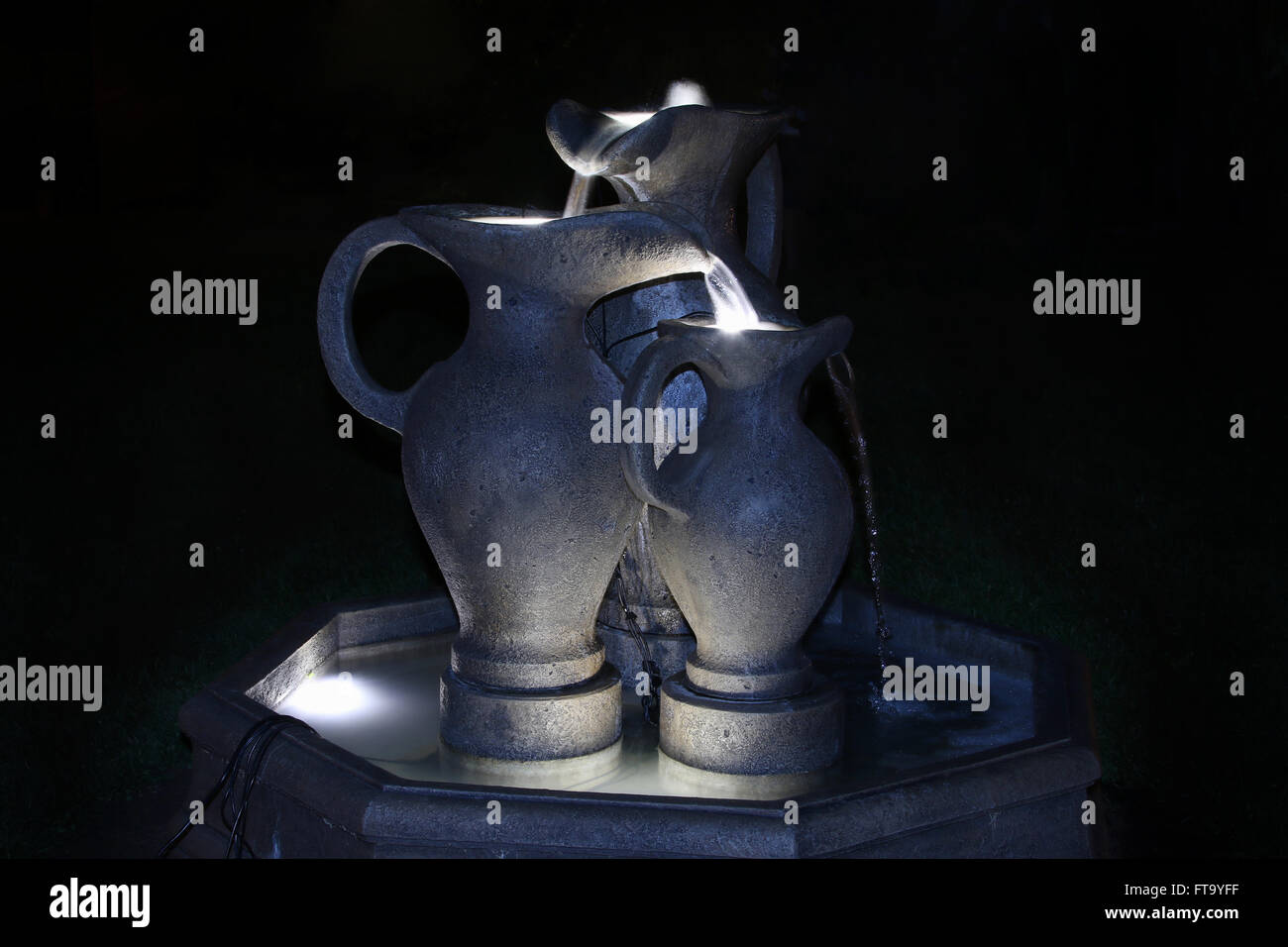 Pitchers pouring sculpture. Water Garden Feature at night. Green Vista ...