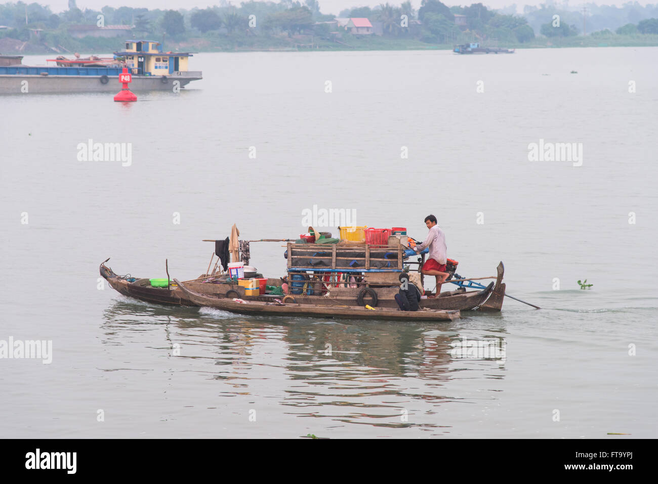 Very small, traditional style, houseboat on Bassac River in the Mekong ...