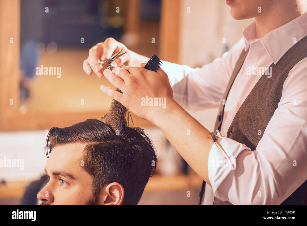 Professional barber cutting hair of his client Stock Photo - Alamy