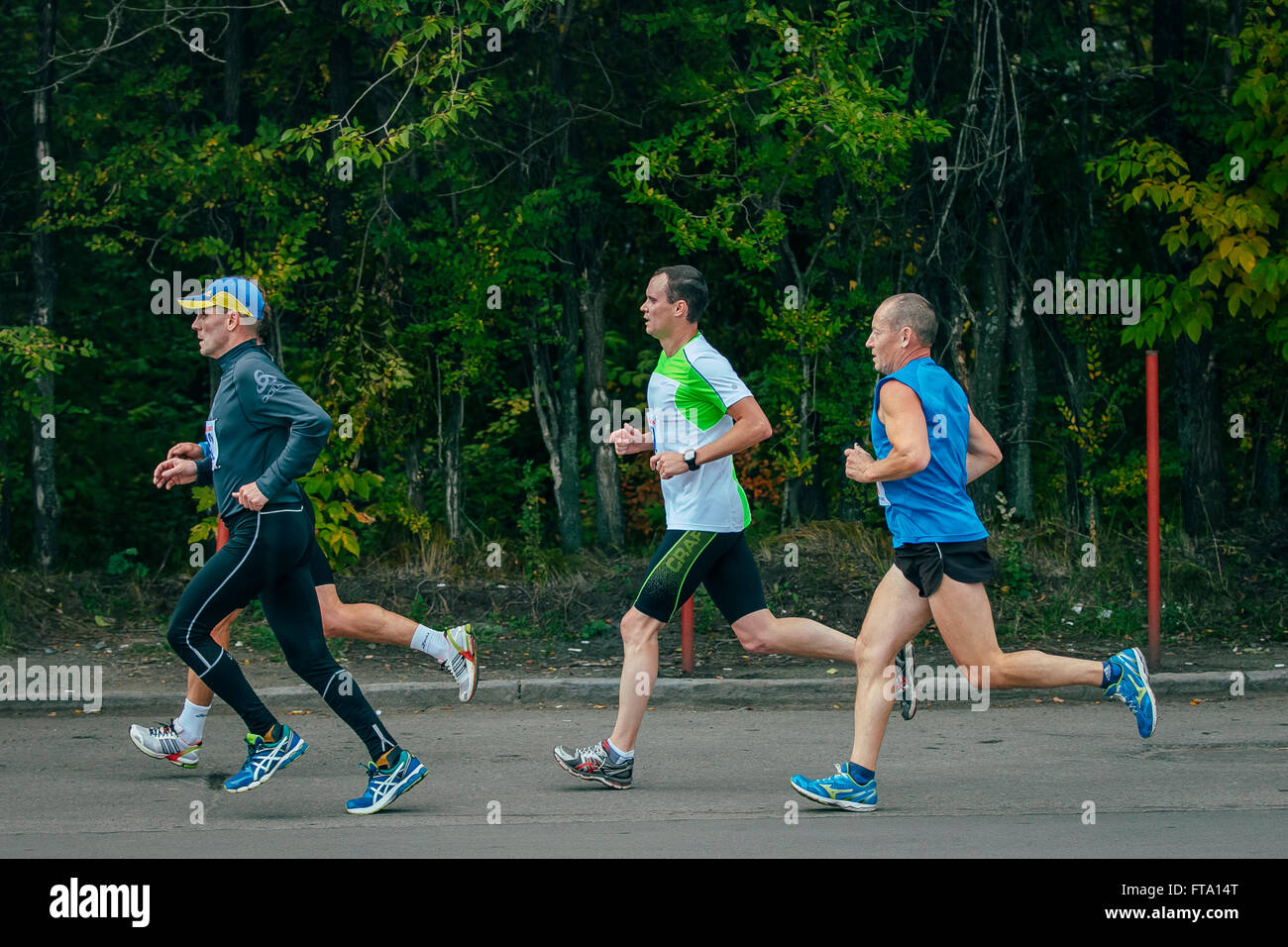 group of men middle age athletes run through Park Stock Photo - Alamy