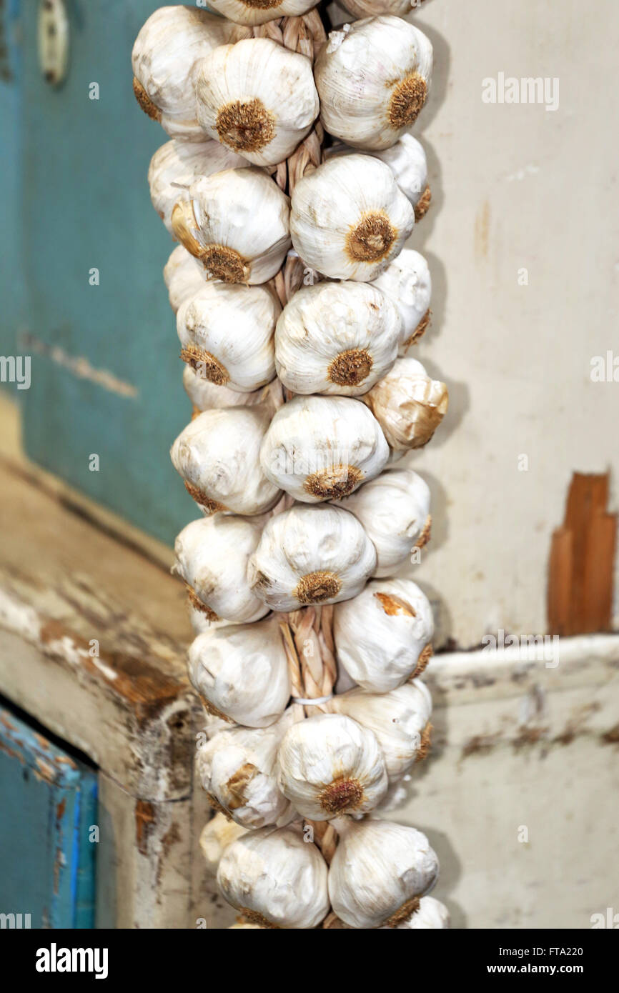 String of garlic bulbs hanging in hungarian rural kitchen Stock Photo ...