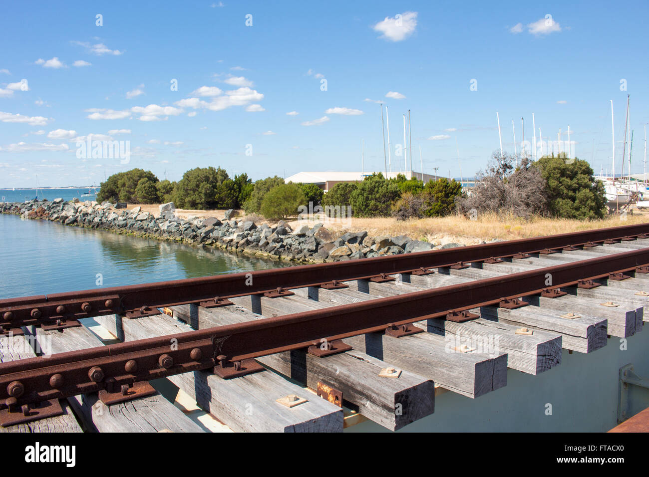 Old rusted unused railway train line over the Leschenault Estuary ...
