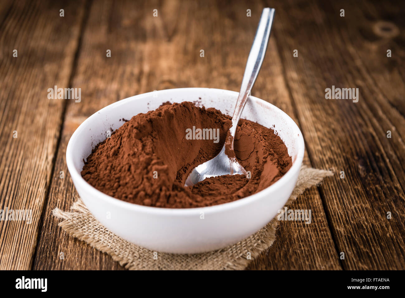 Natural Cocoa powder (detailed close-up shot) on an old wooden table ...