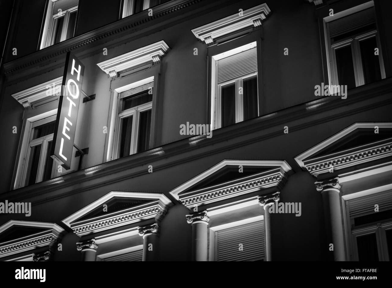Glowing hotel sign in night on old building. Architecture of Budapest ...