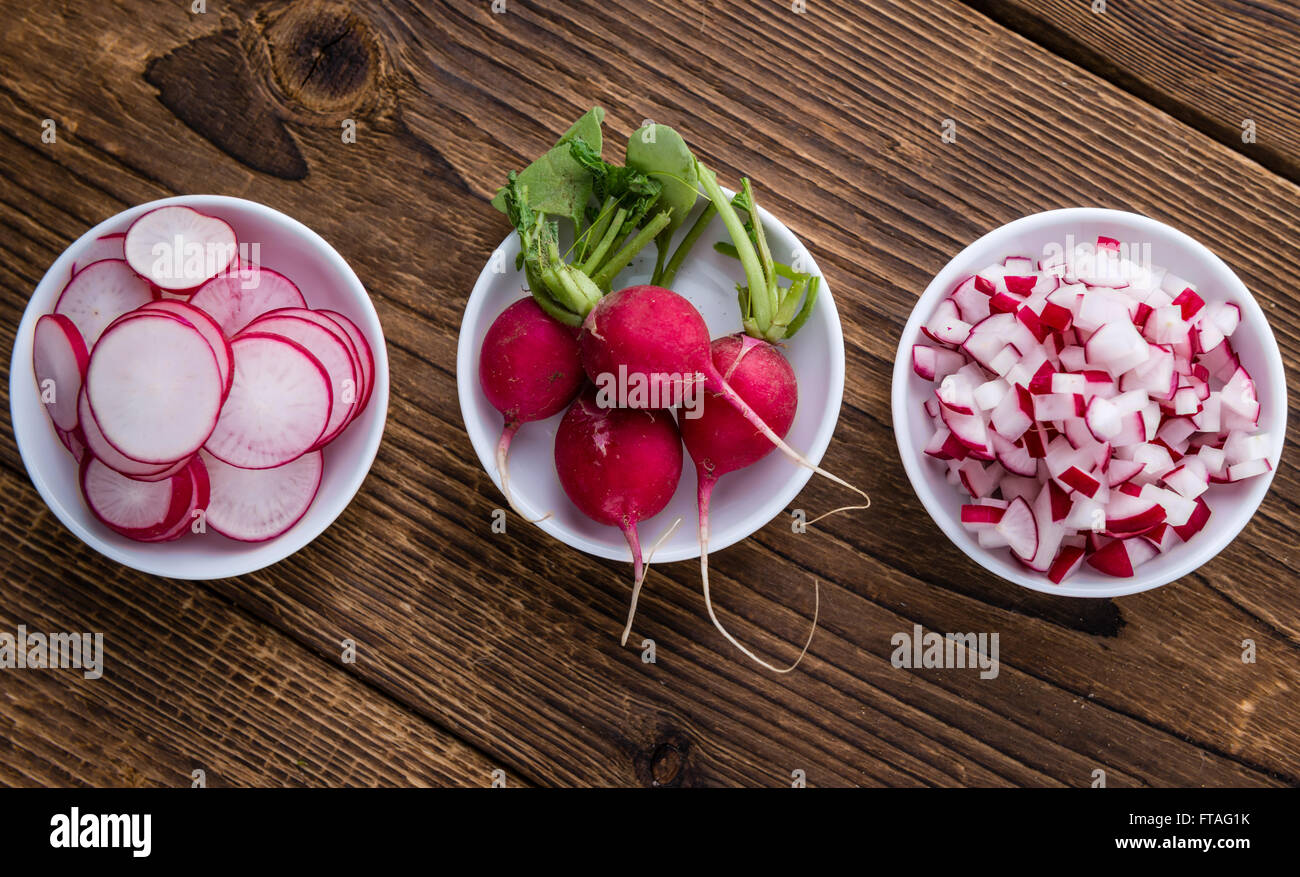 Radishes (whole, sliced and diced) as detailed close-up shot (selective ...