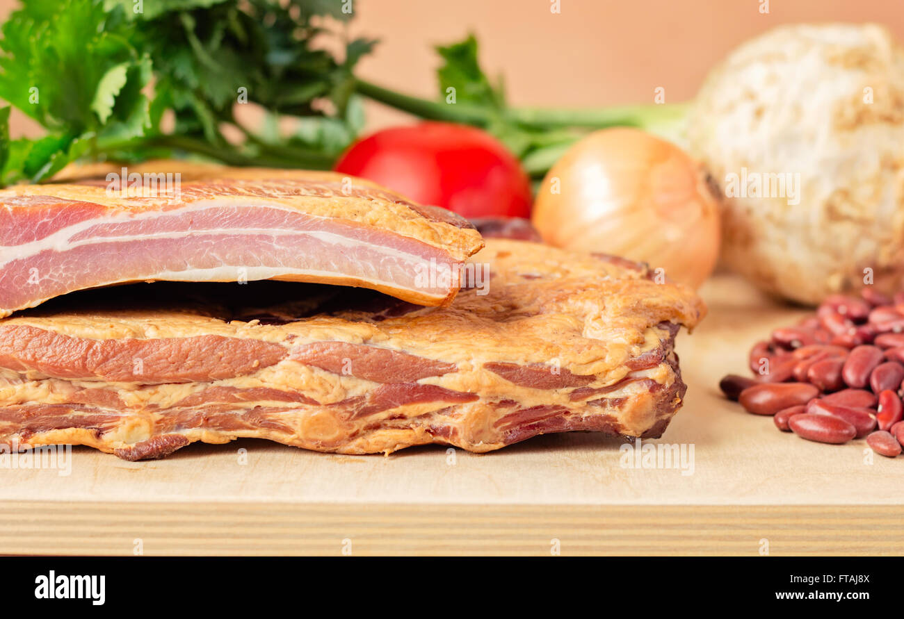 Stacked smoked pork ribs with dry red beans and vegetables Stock Photo ...