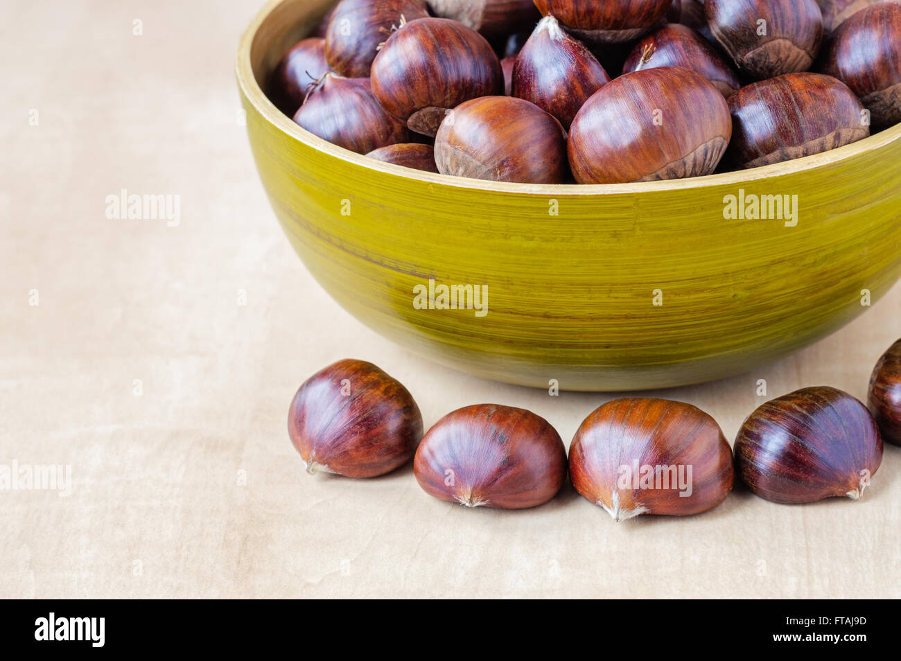 Front view of green bamboo bowl of fresh chestnuts Stock Photo - Alamy
