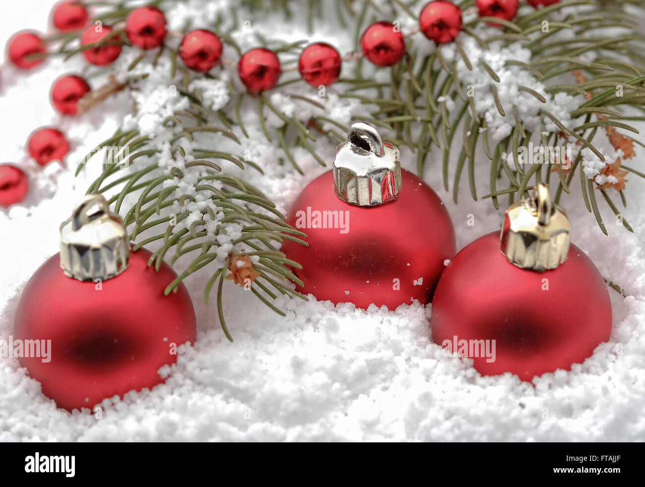 Red Christmas balls in the snow Stock Photo - Alamy