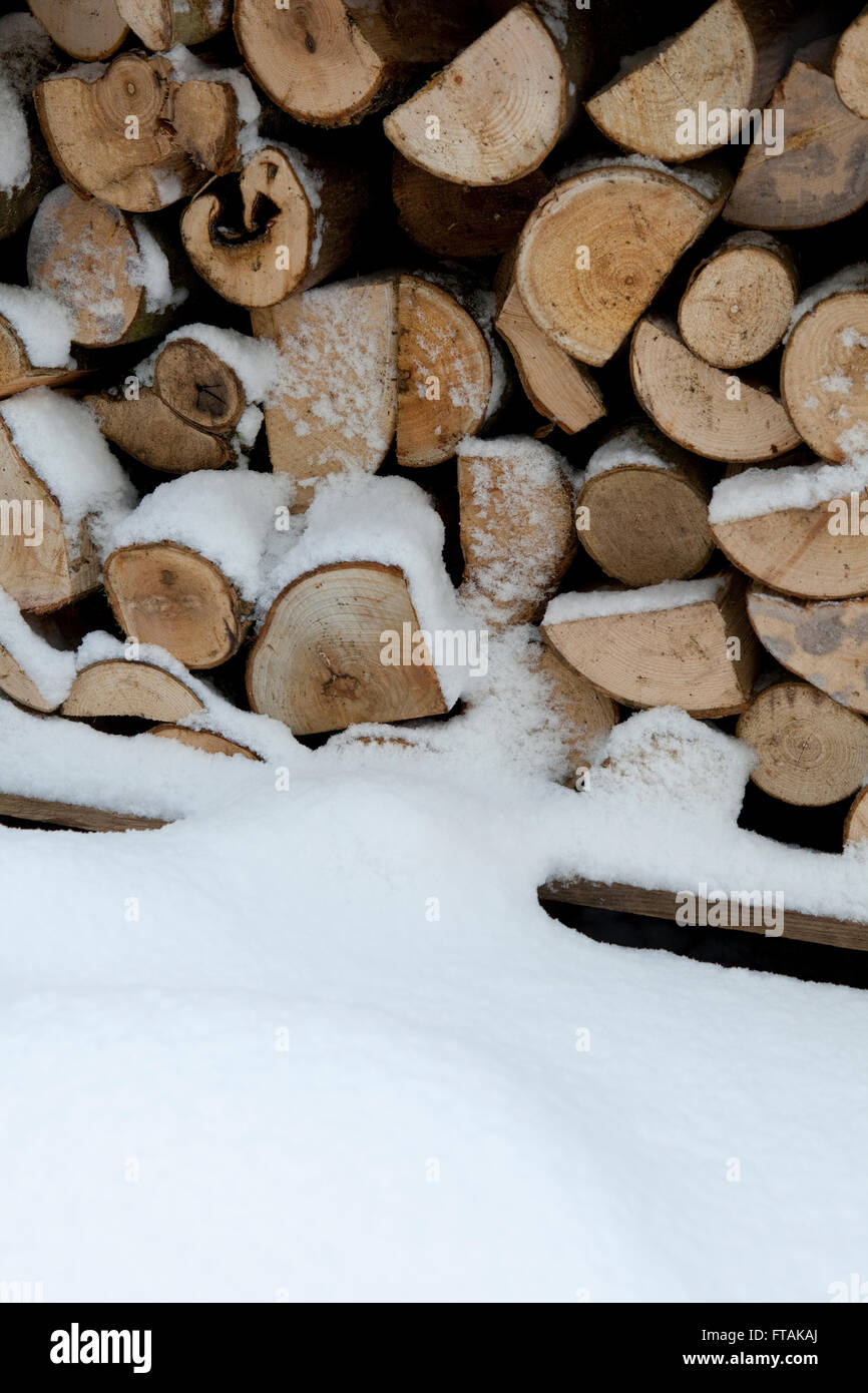 Log store in the snow Stock Photo - Alamy