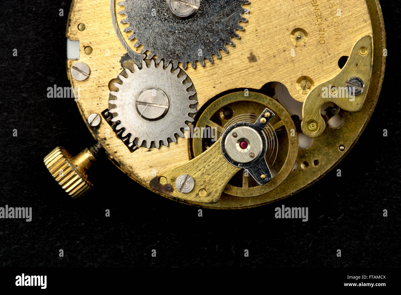 Inside workings of old pocket watch on a black background Stock Photo ...