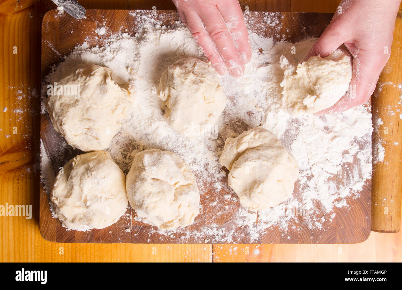 Making dough by female hands on wooden table background Stock Photo - Alamy