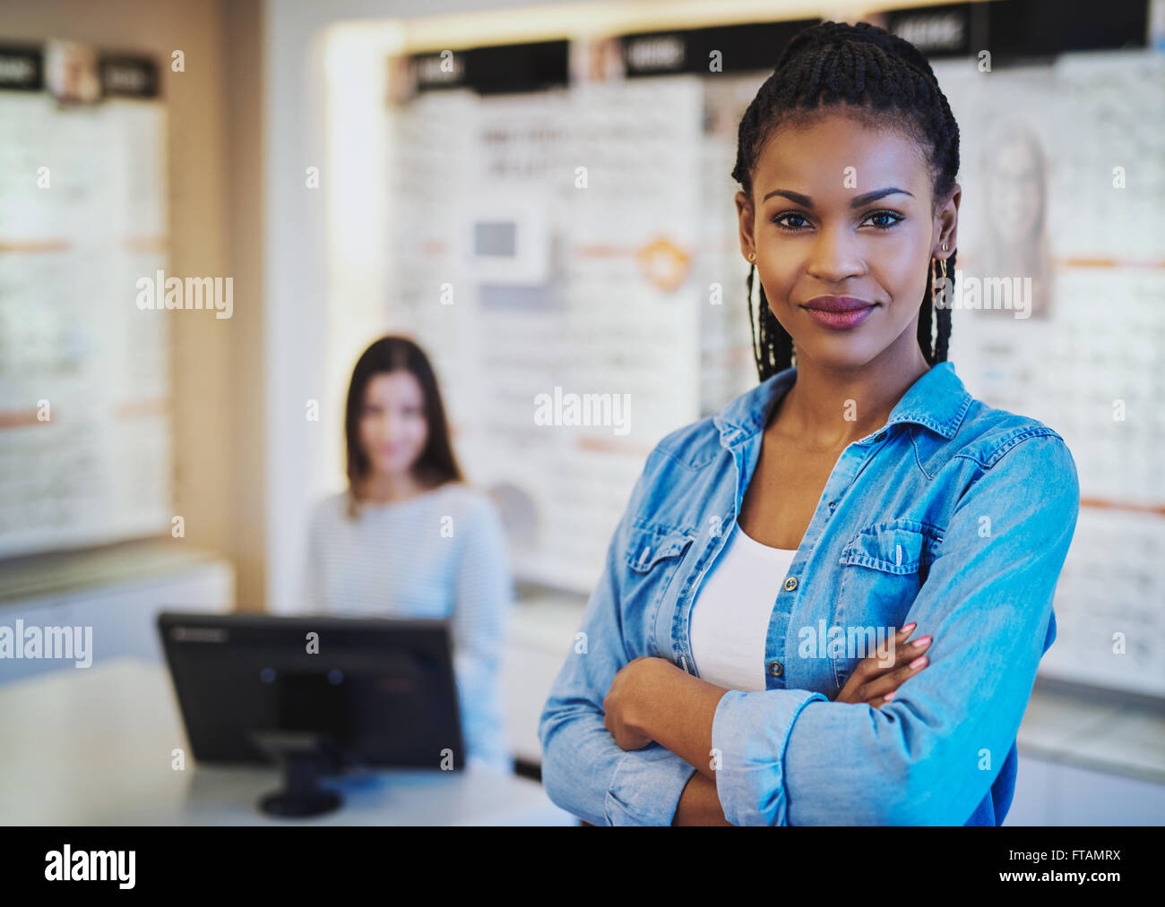 Black female shop owner standing in front of colleagues Stock Photo - Alamy