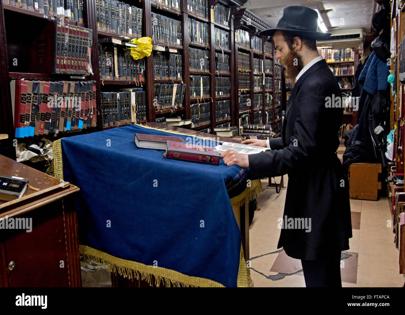 Portrait of a religious Jewish man praying alone in a room at a ...