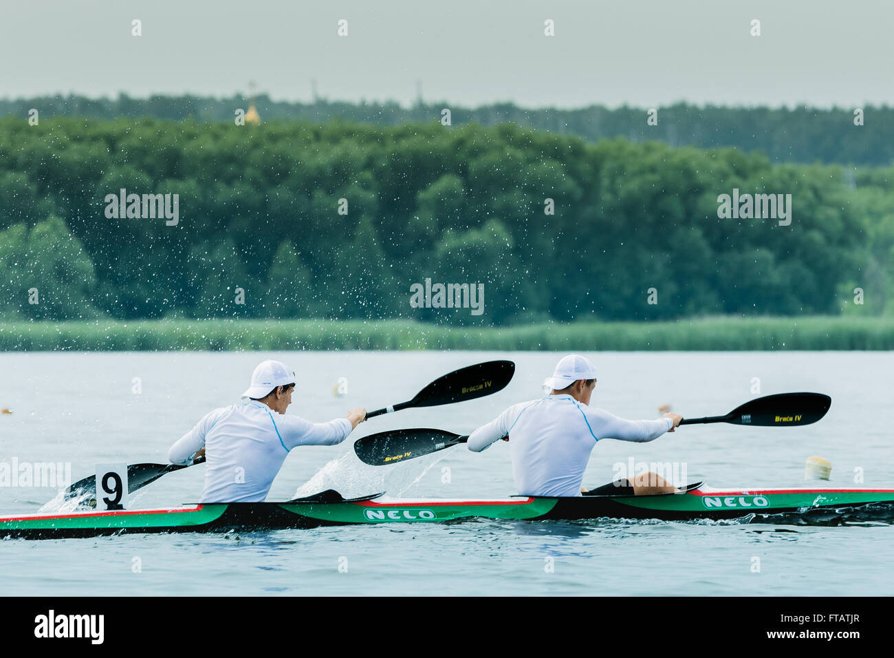 Young men rowing boat hi-res stock photography and images - Alamy