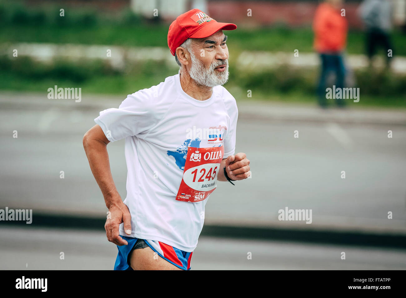 Omsk, Russia - September 20, 2015: old man runner running on street ...