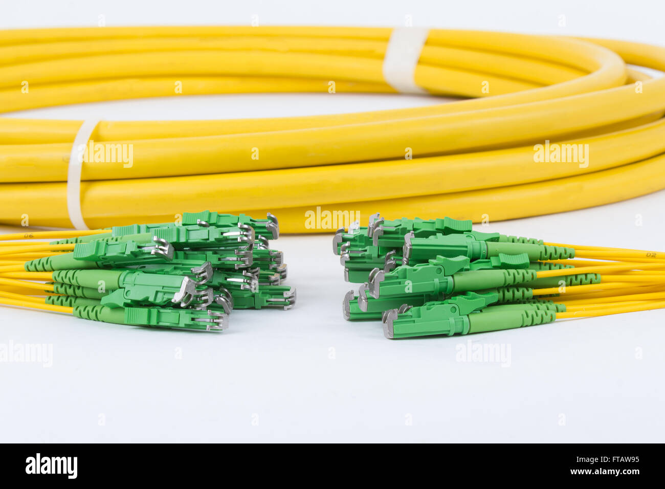 fiber optic E2 (LSH) pigtail, patchcord connectors on white background ...