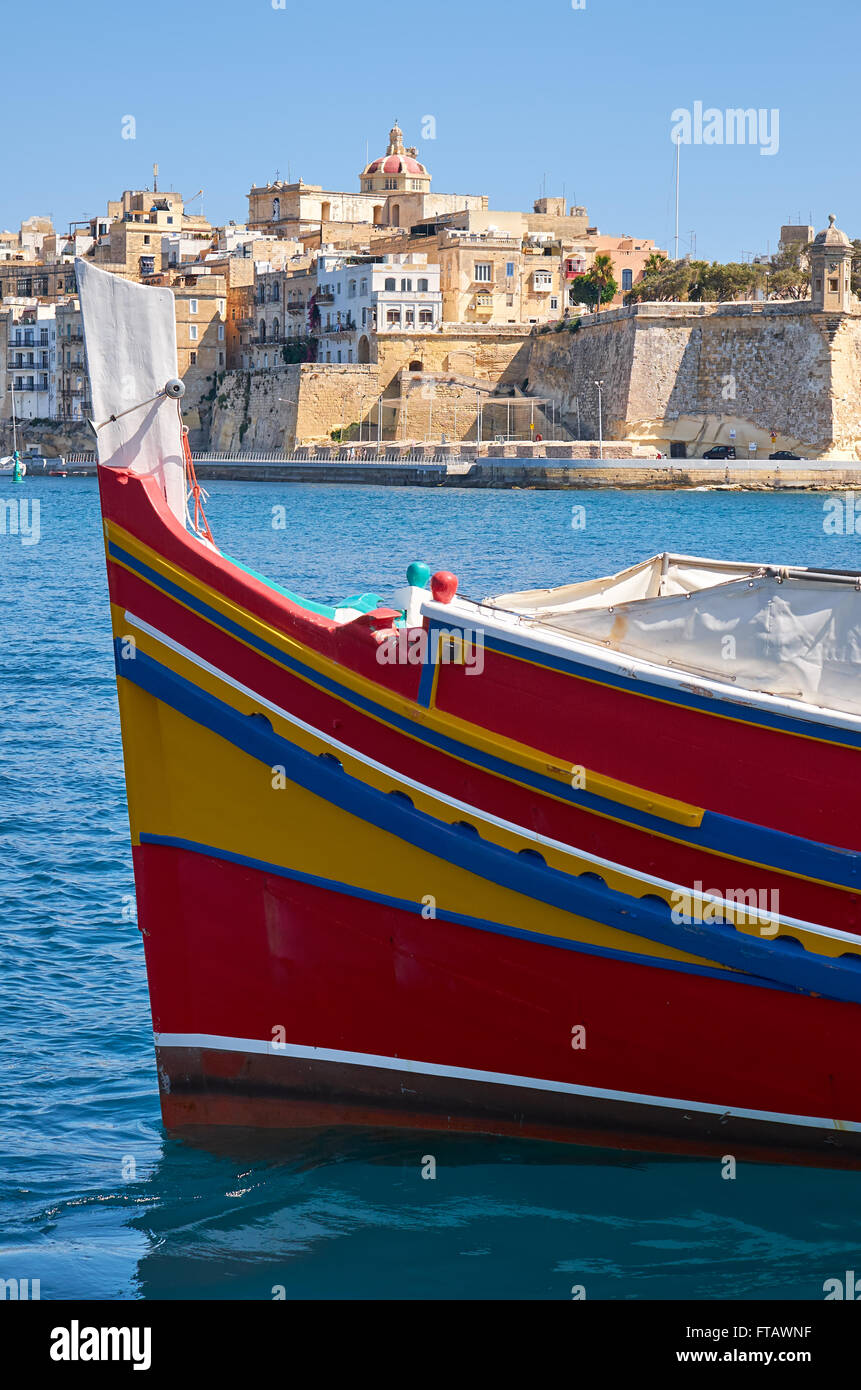 The front of the traditional maltese boat Luzzu entering the frame with ...