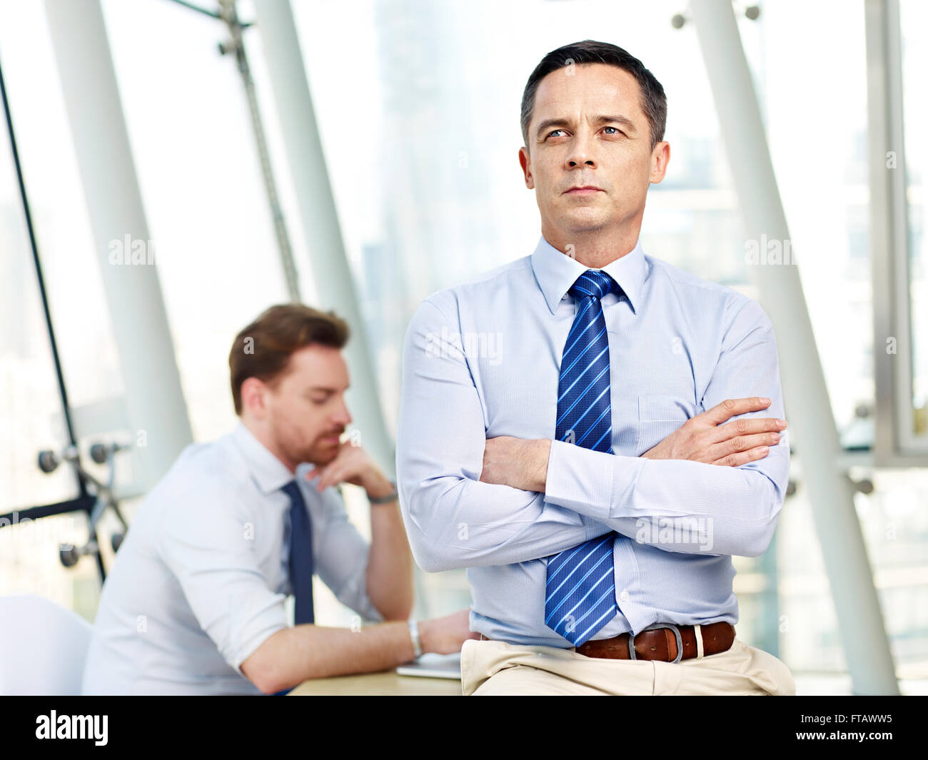 Man sitting with arms crossed hi-res stock photography and images - Alamy