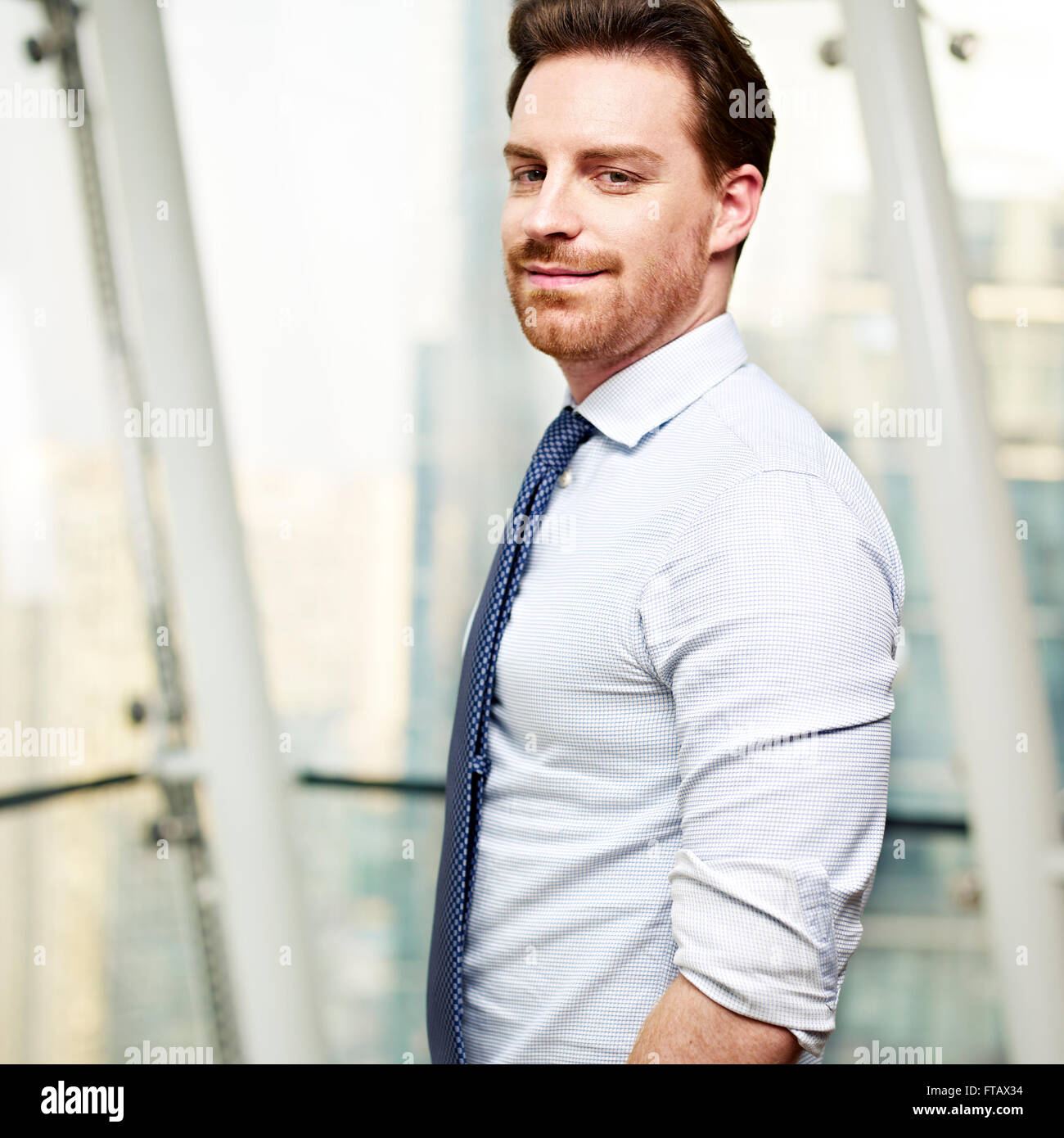 portrait of a business executive standing by the window in office Stock ...