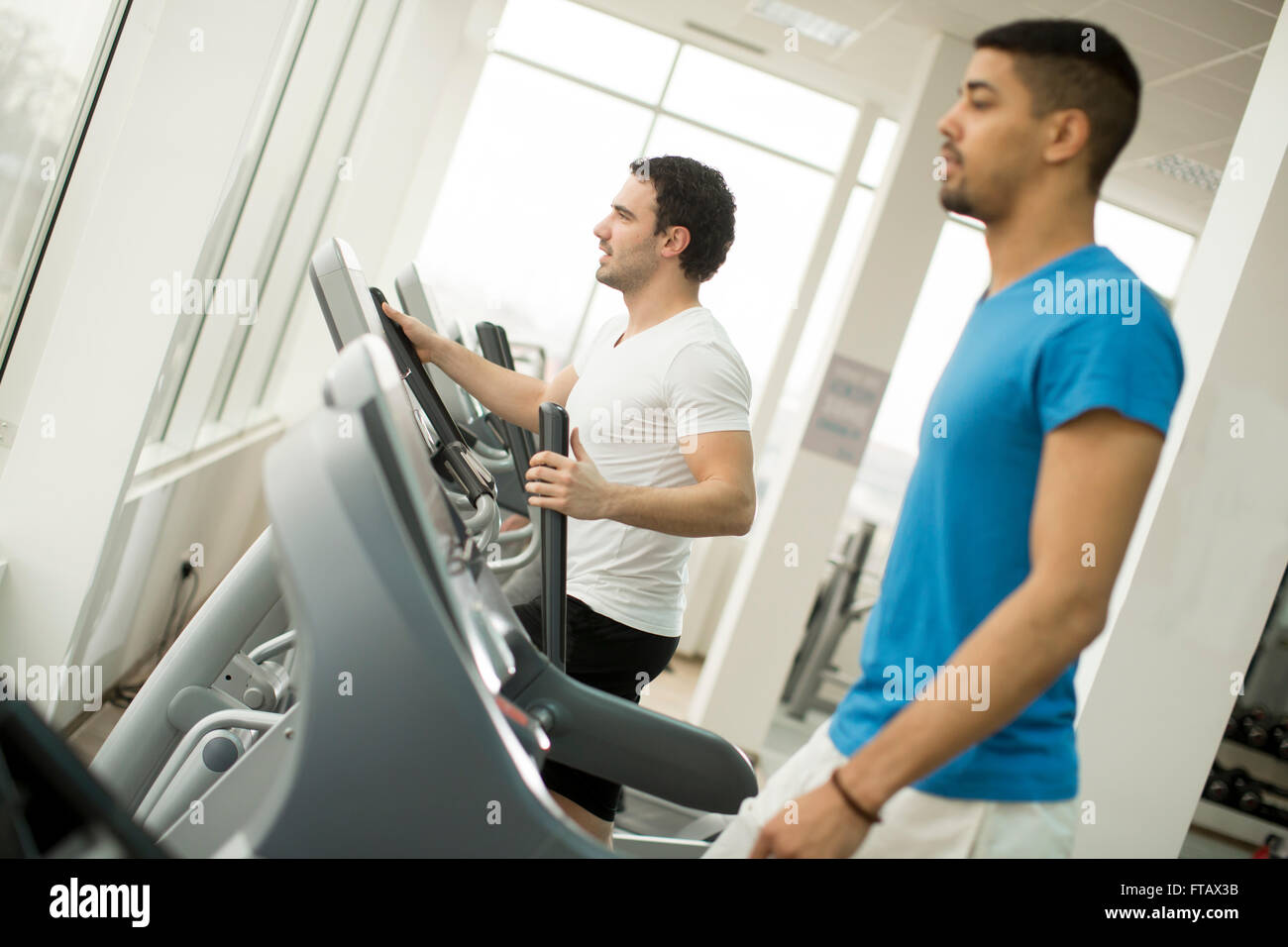 Young man running on treadmill in gym hi-res stock photography and ...