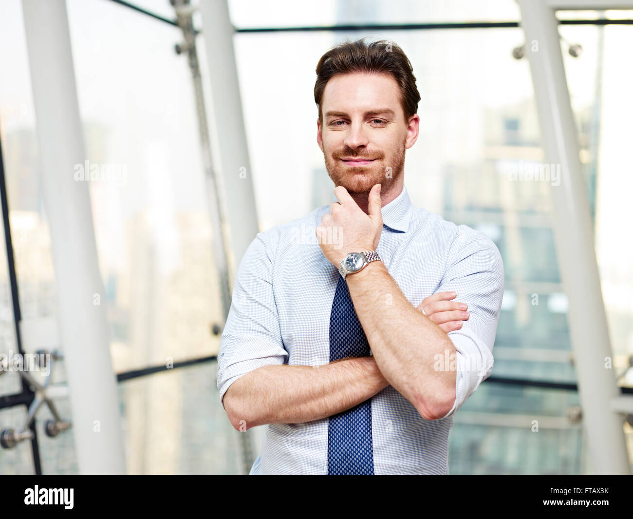portrait of a business executive standing by the window in office Stock ...