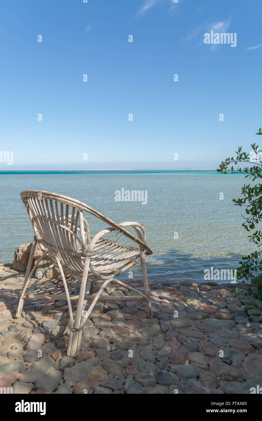 Wicker Chair on Beach Stock Photo - Alamy