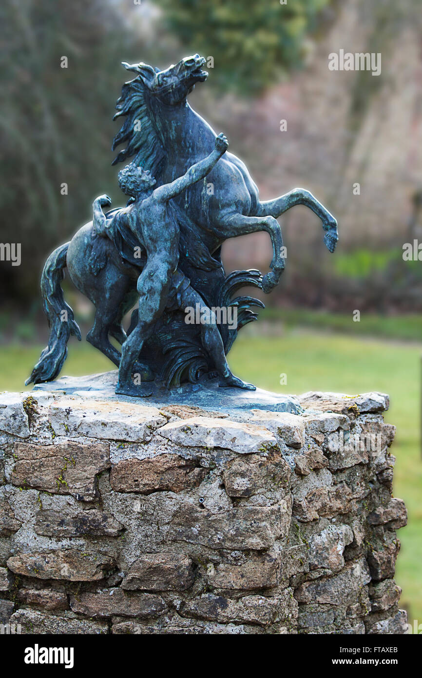 Bronze statue figurine of a man reaching up to steady a rearing up ...