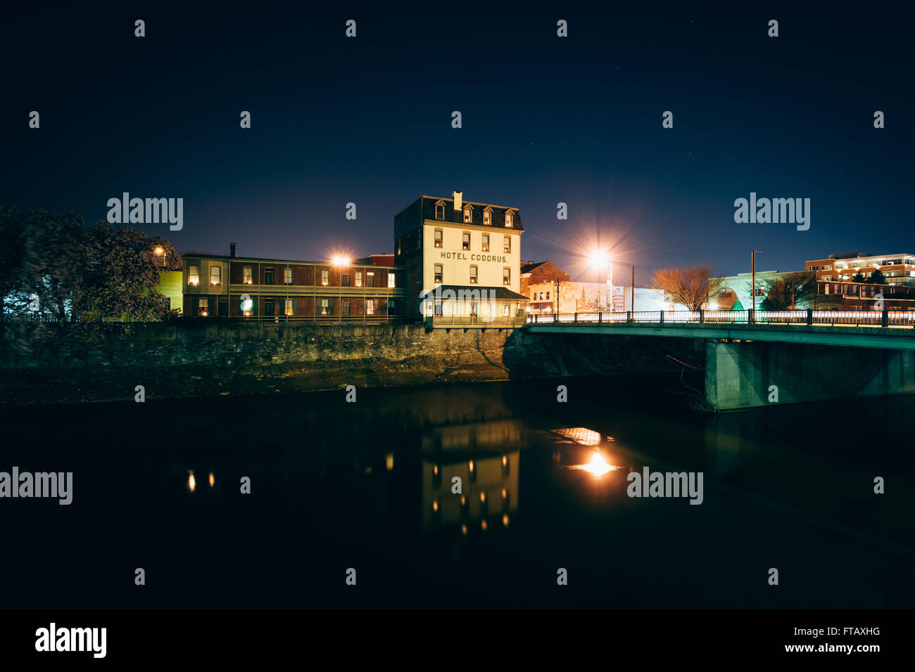 Bridge and buildings along the Codorus Creek at night, in York ...