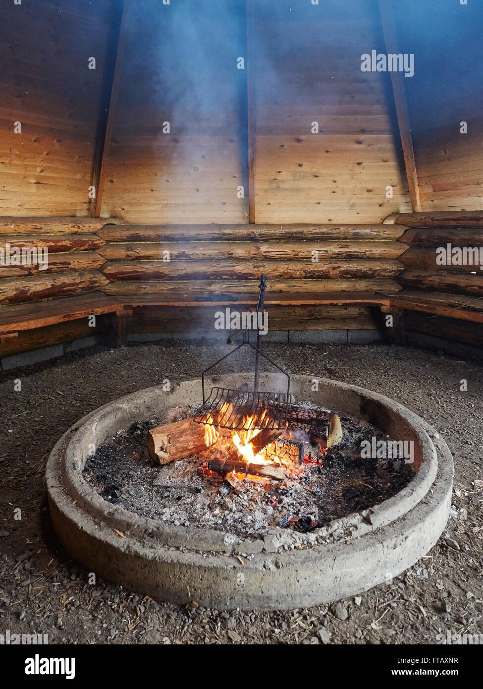 Smoke rising from outdoor fire place in a barbecue hut Stock Photo - Alamy