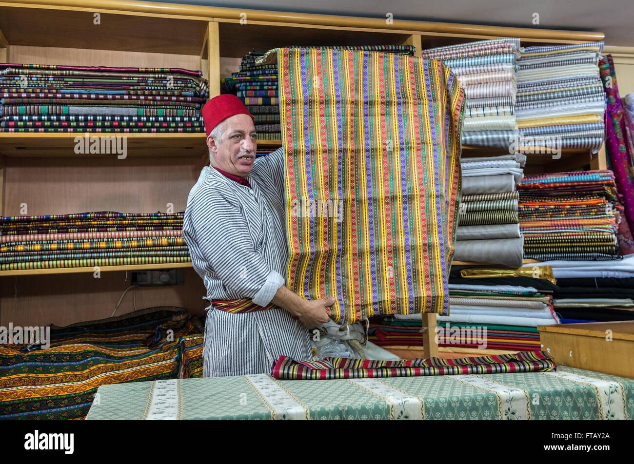 Bilal Abu Khalaf, dealer of imported orient fabrics, shows textiles in ...