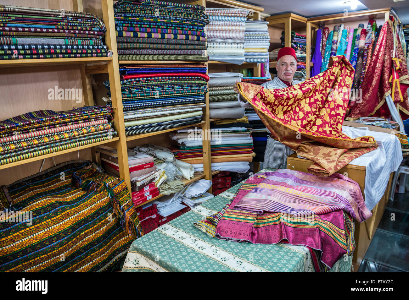 Bilal Abu Khalaf, dealer of imported orient fabrics, shows textiles in ...