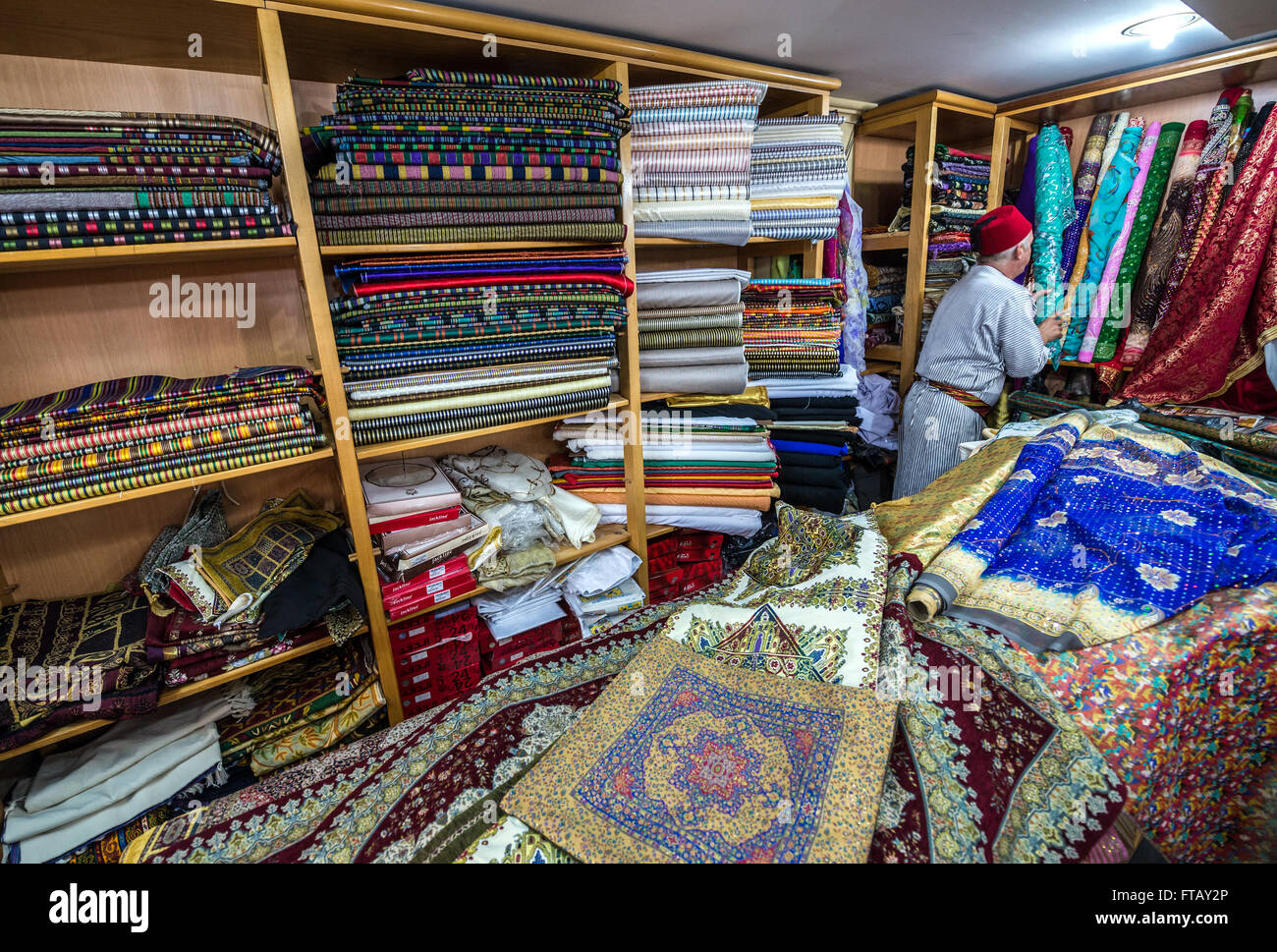 Bilal Abu Khalaf, dealer of imported orient fabrics, shows textiles in ...