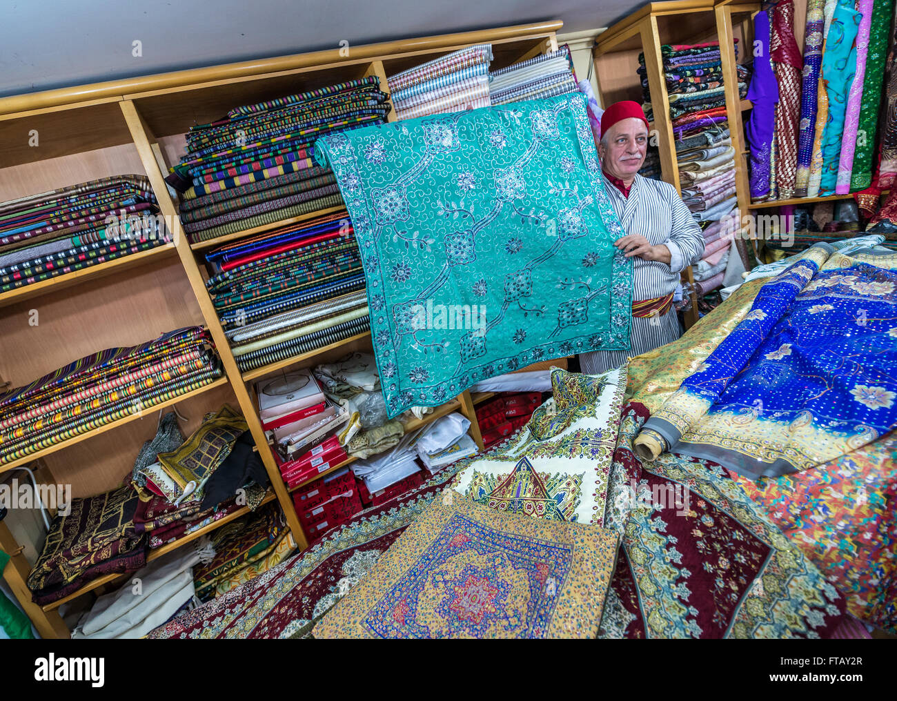 Bilal Abu Khalaf, dealer of imported orient fabrics, shows textiles in ...