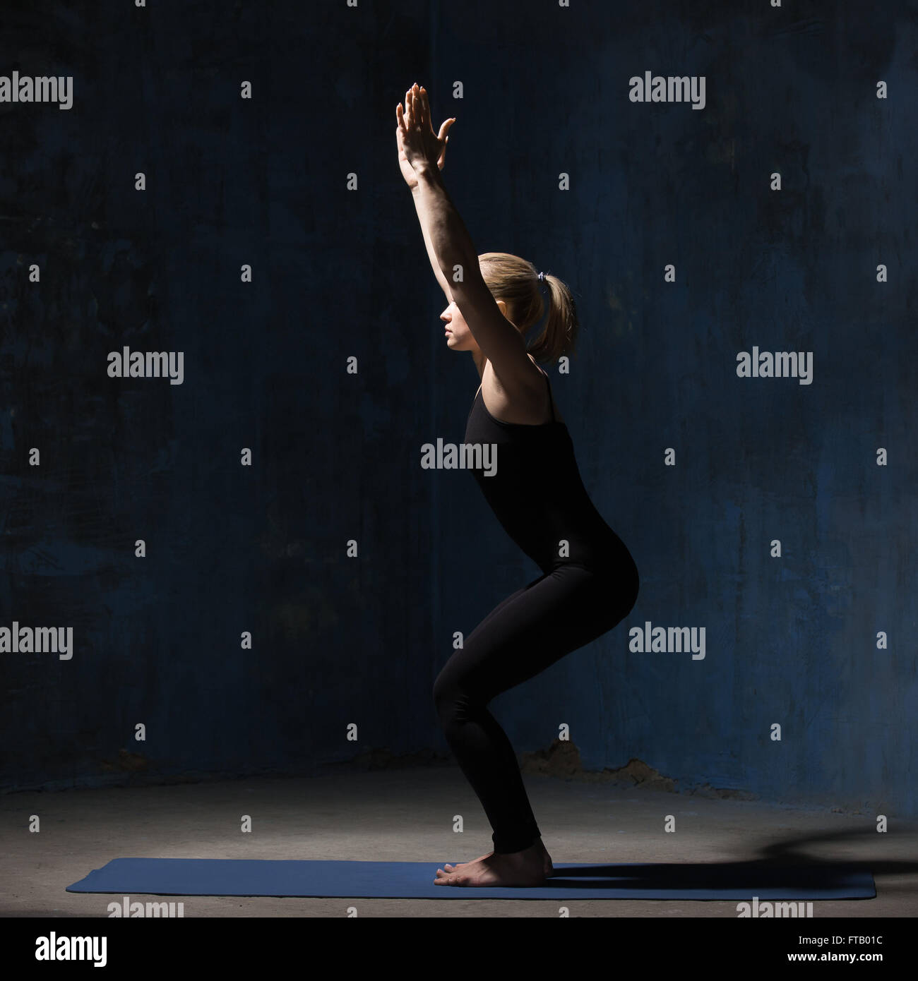 Beautiful sporty fit young woman working out indoors against grunge ...