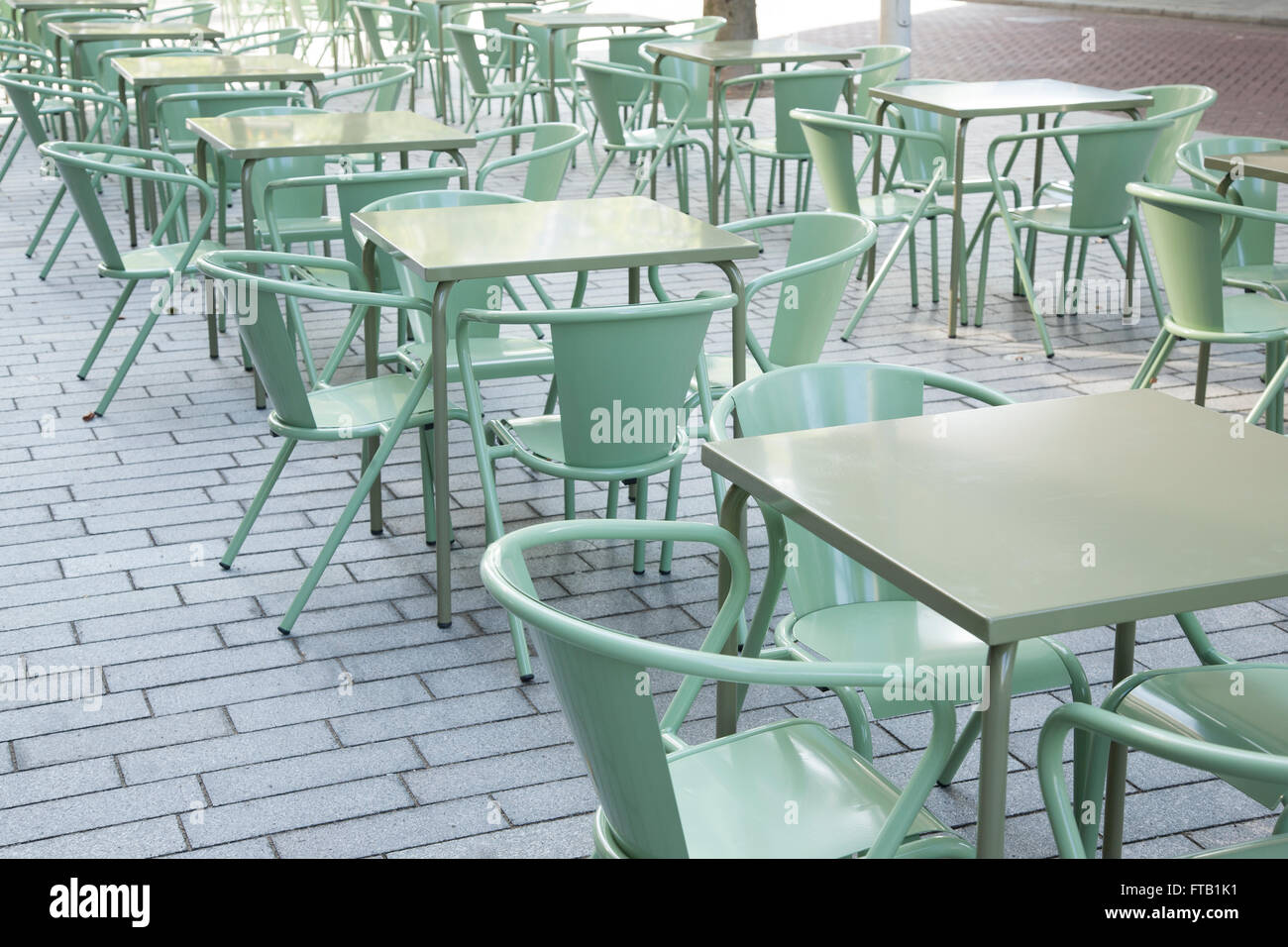 Green Cafe Tables and Chairs in Urban Setting Stock Photo - Alamy