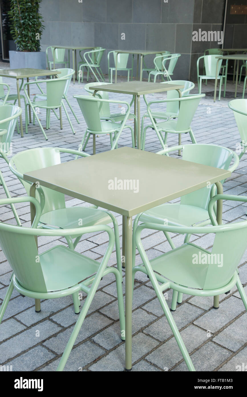 Green Cafe Tables and Chairs in Urban Setting Stock Photo - Alamy