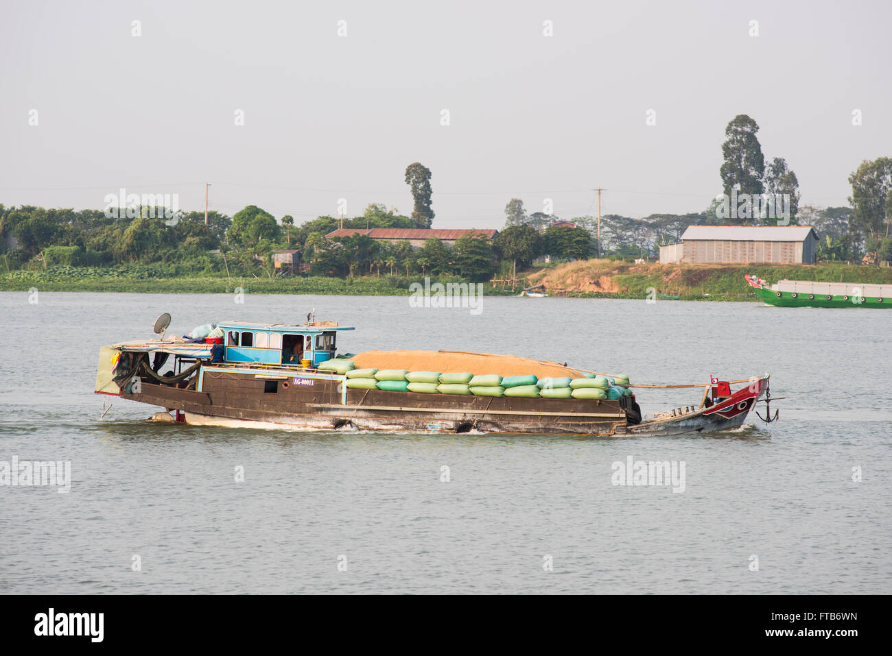 Fully loaded rice barge on the Bassac River in Vietnam Stock Photo - Alamy