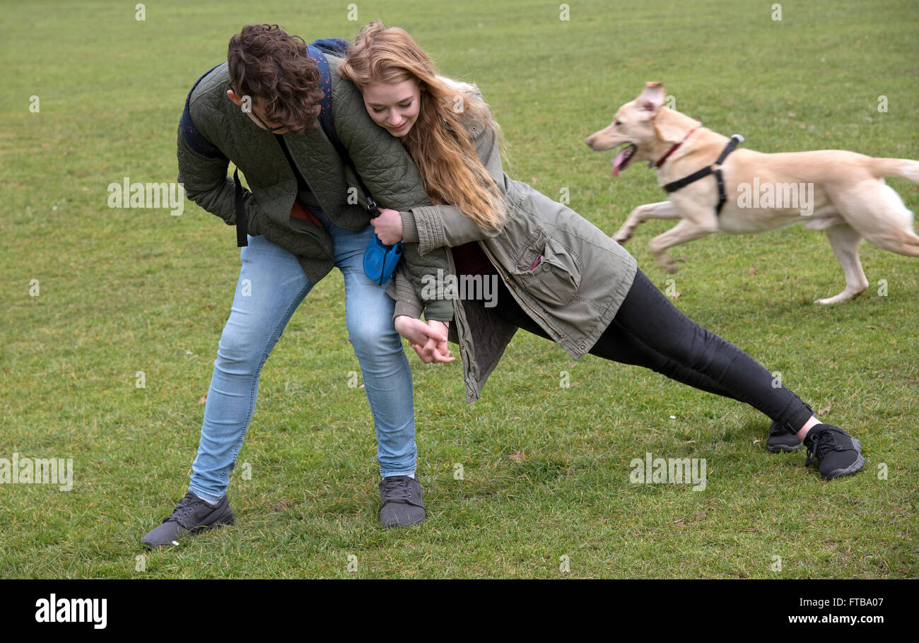 Teenagers playing a push and shove game in a park Stock Photo - Alamy