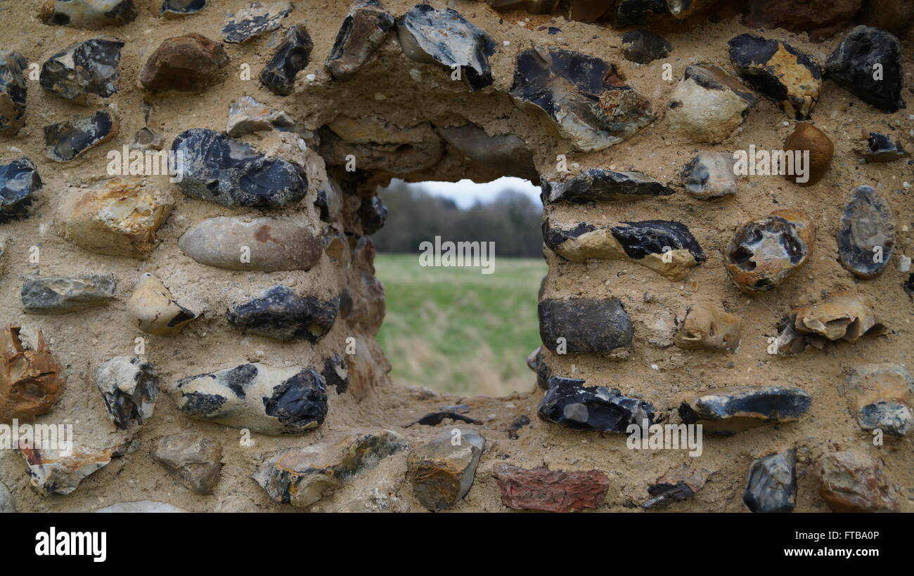 Looking through a stone window at the archaeological ruins of Tilty ...