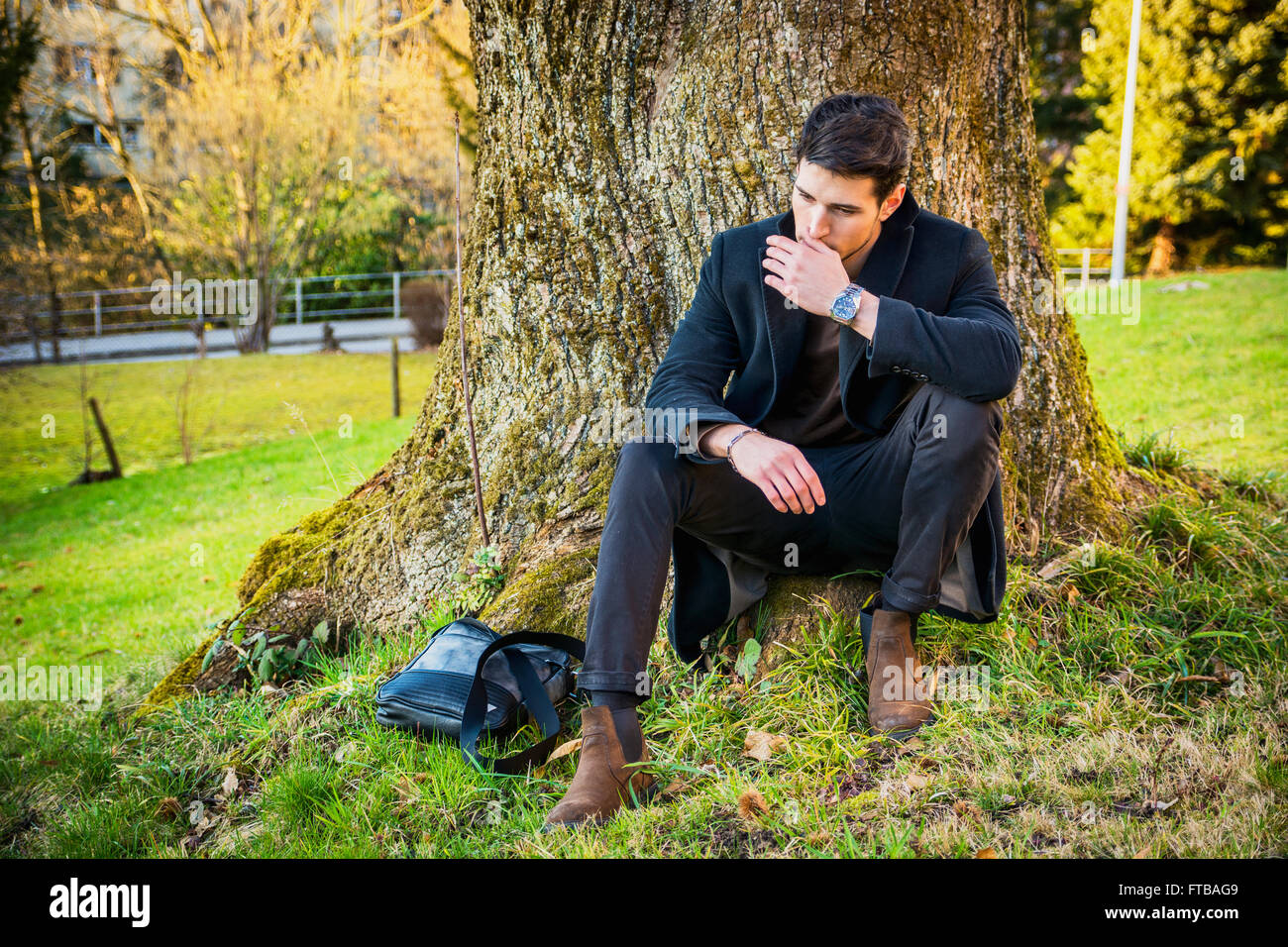 Person Leaning Against A Tree