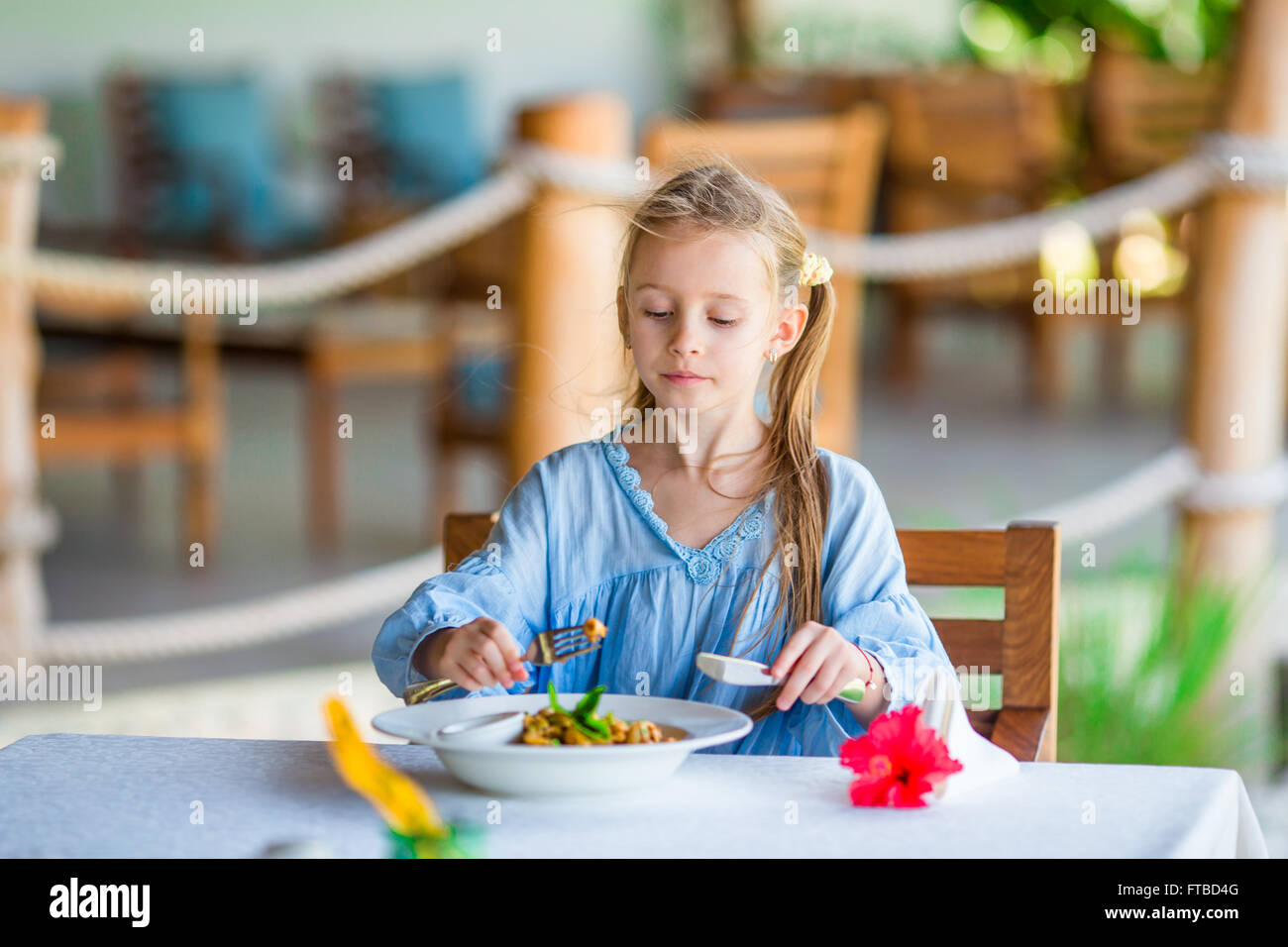 Adorable little girl having lunch at outdoor cafe Stock Photo - Alamy