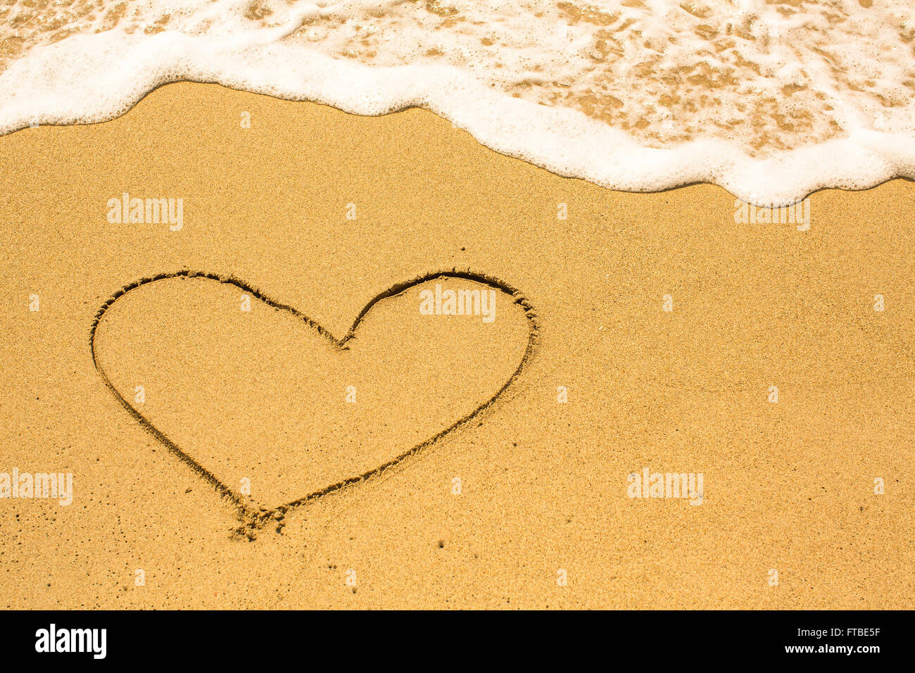 Heart drawn on the sand of a sea beach Stock Photo - Alamy