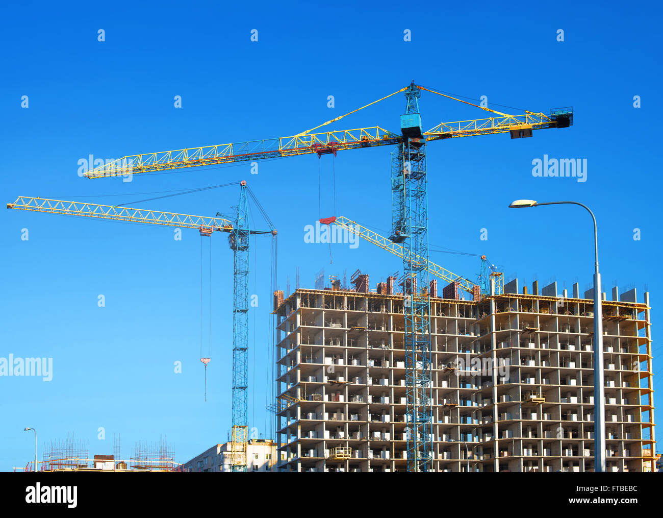 yello crane and building construction site against blue sky Stock Photo ...