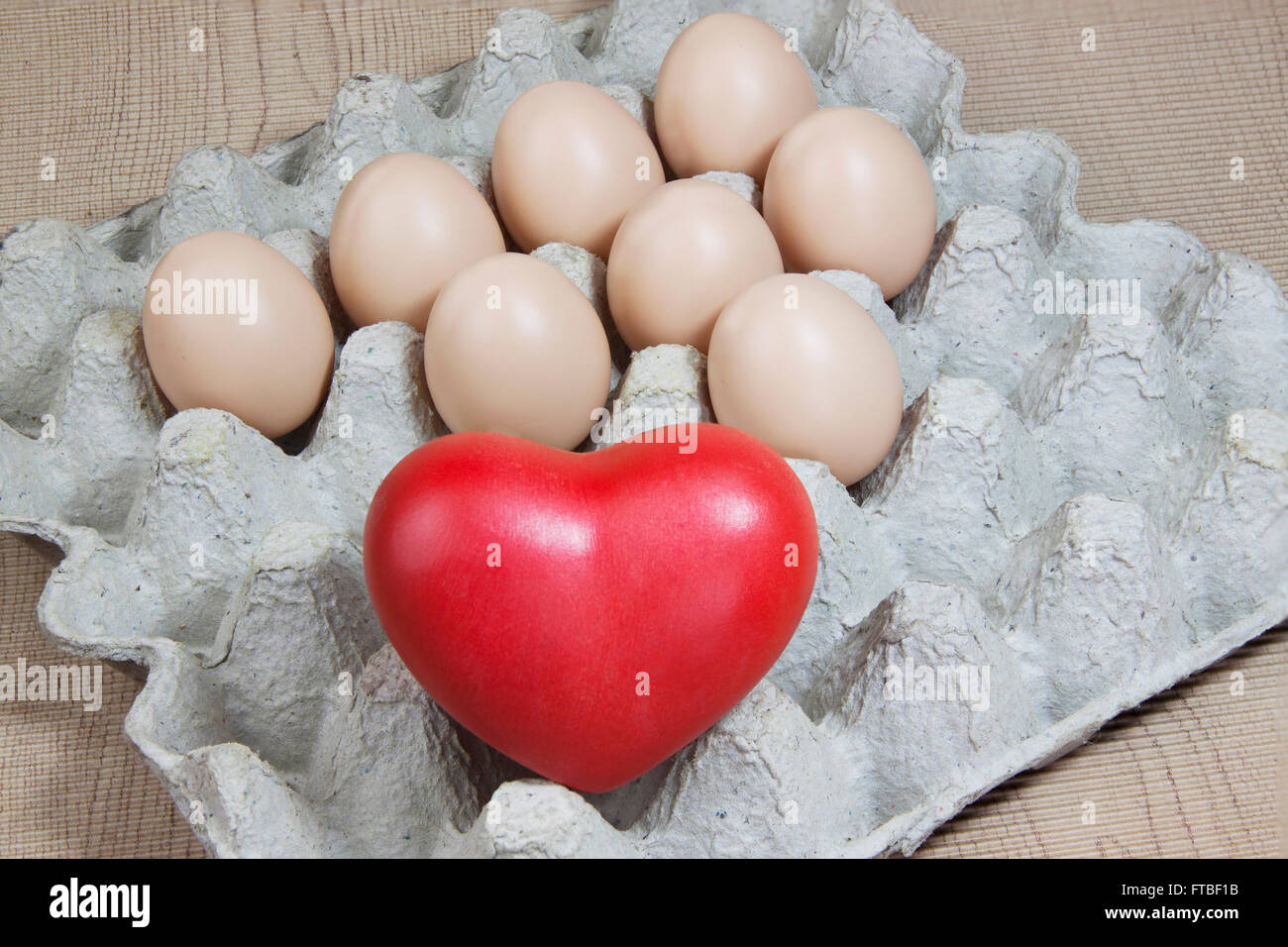 Heart and eggs on paper panel and paper pattern wood Stock Photo - Alamy