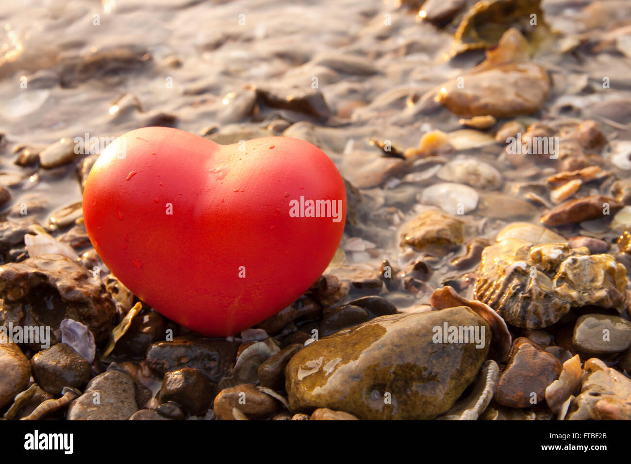 red shape heart on rock and shell beach nature Stock Photo - Alamy